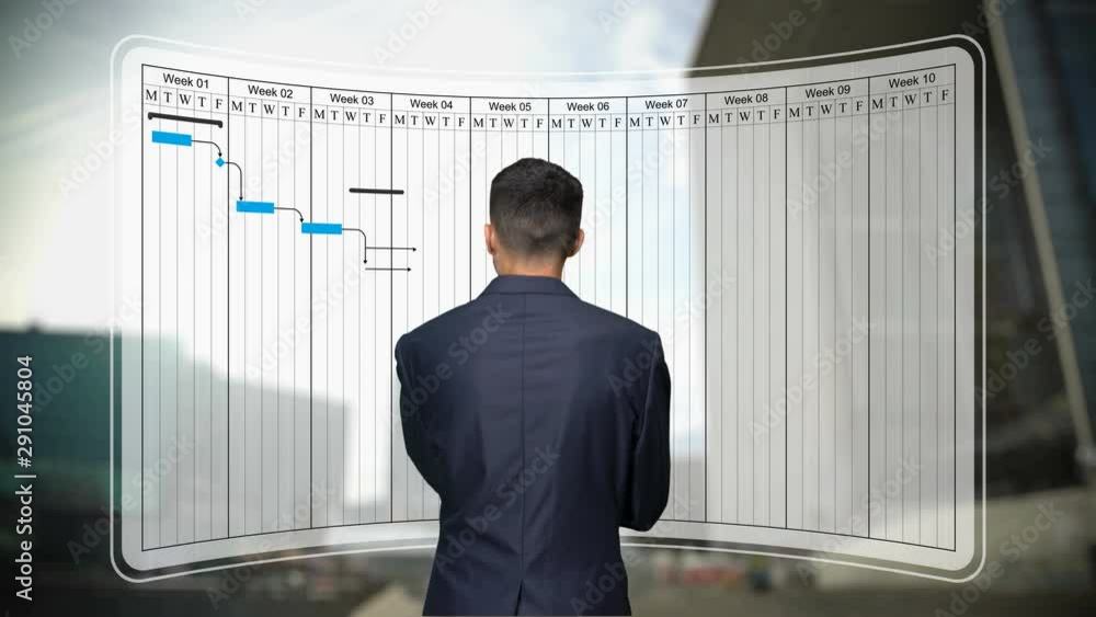 Businessman looks to Gantt chart, project schedule harmonogram work ...