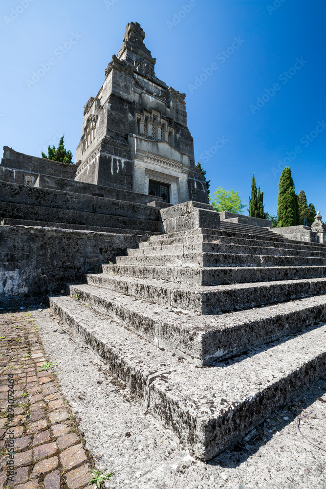Low angle shot of a mausoleum consisting in a flight of steps and a ...