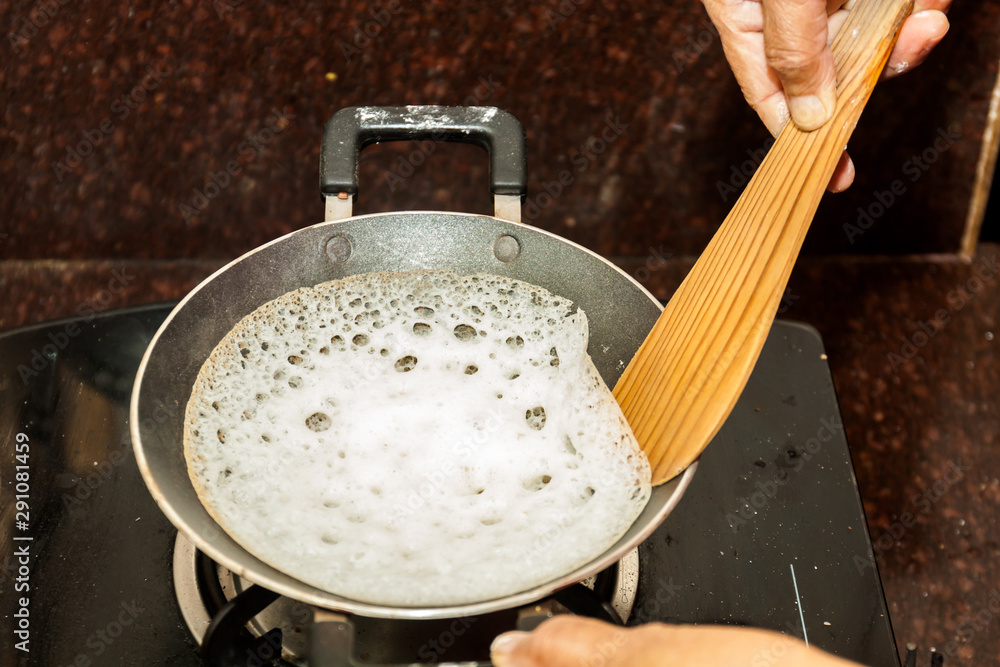 Preparation of Paalappam, Kerala's dish, in a appa chatti, nonstick pan ...