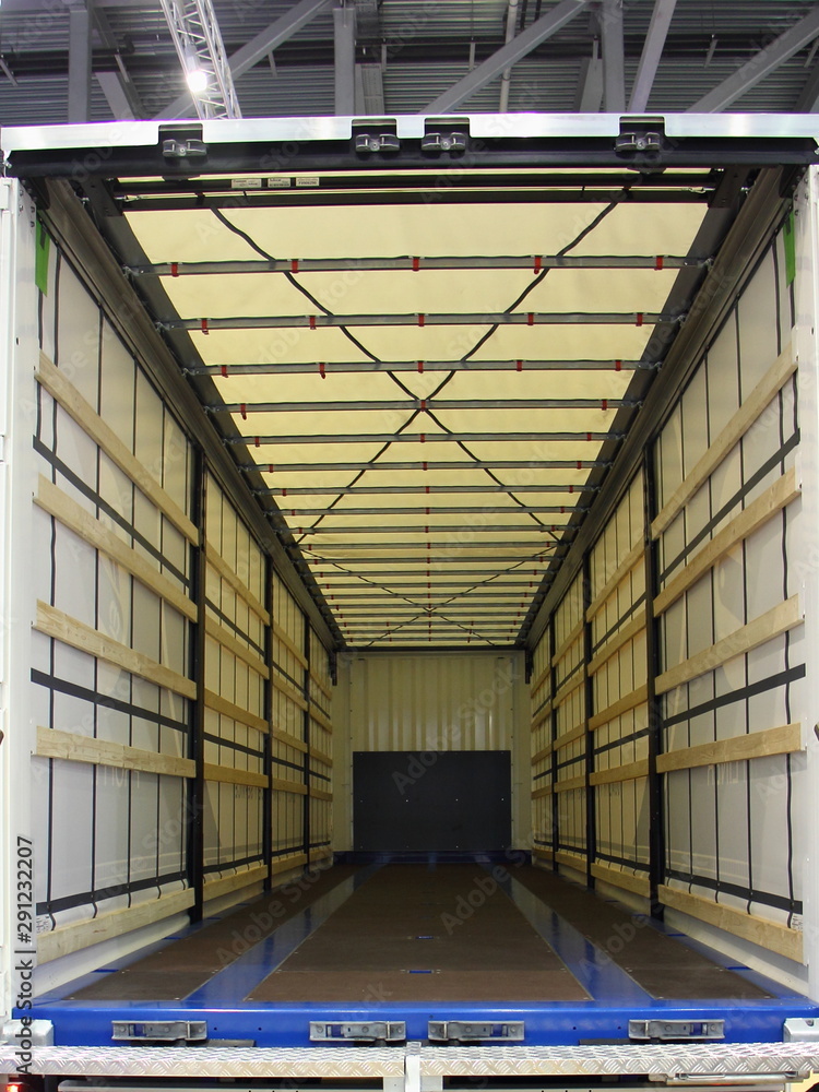 Foto de New empty semi trailer indoor view close up, truck ...