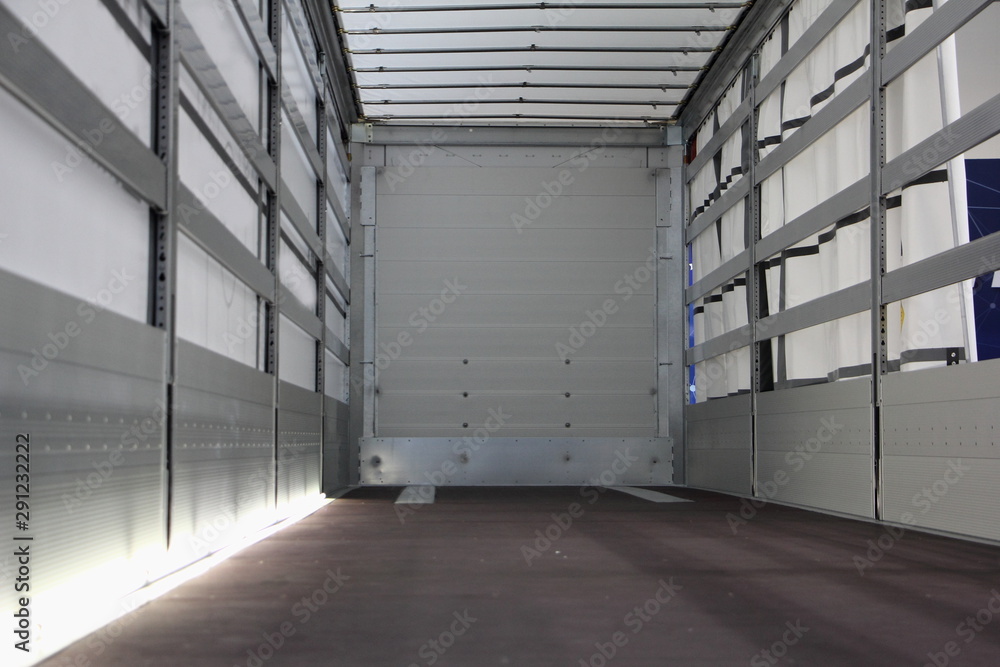 New truck empty semi trailer with clean floor, inside rear view close ...