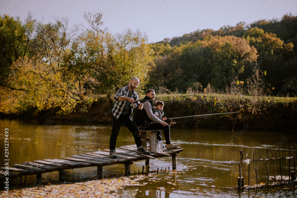 Fotka „Beautiful place at nature amazing lake , two men and one litt ...