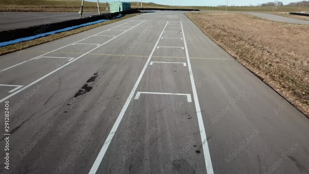 A fly away from the start finish line of an icy cold race track that is ...