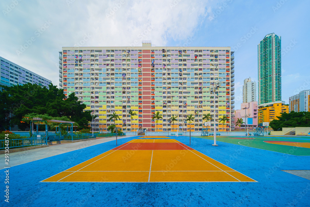Colorful rainbow pastel building with basketball court and facade ...