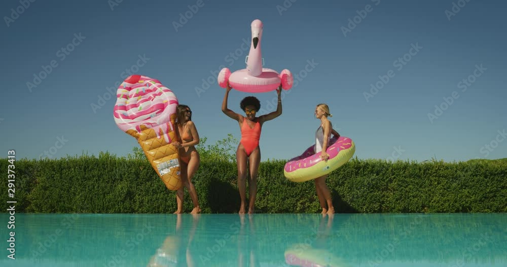 Slow motion of young multi-ethnic girlfriends in bikinis are having fun to enjoy their summer ...