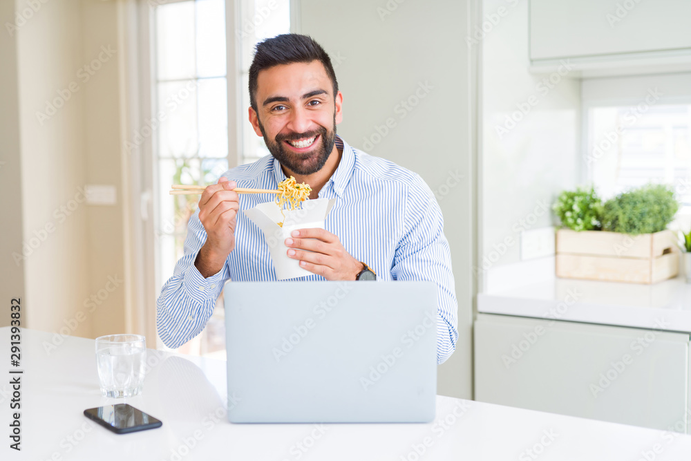 Business man eating asian food from delivery while working using ...
