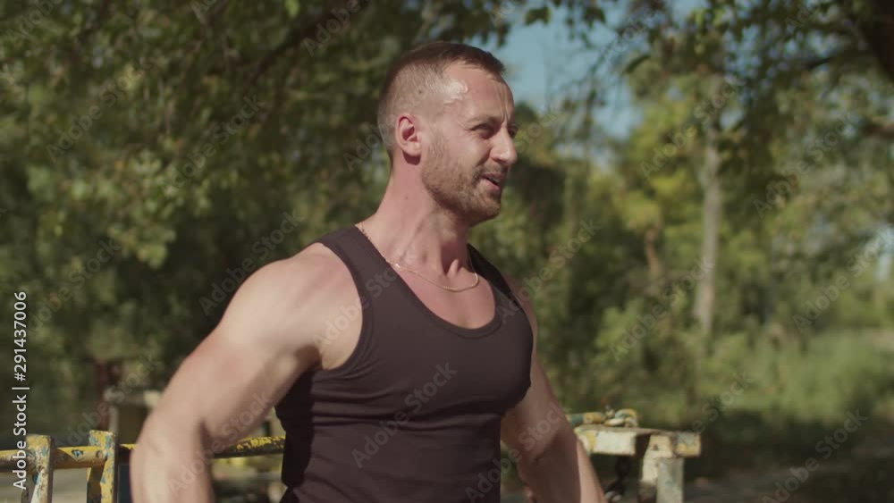 Portrait of brutal concentrated muscular bodybuilder performing ...