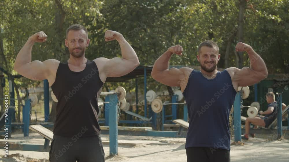 Cheerful handsome muscular built bodybuilders with well trained bodies ...