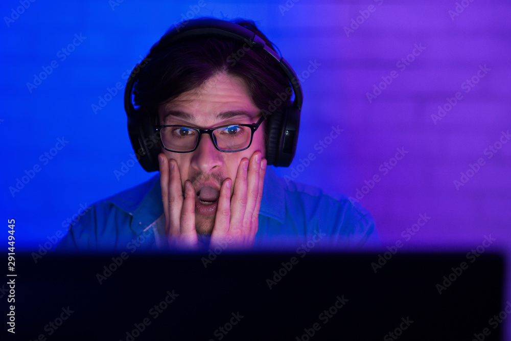 Gamer concept. Terrified gamer playing games on computer Stock Photo ...