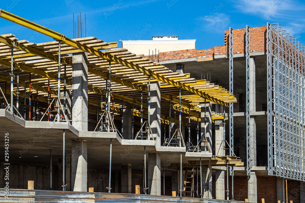 Construction site background. Hoisting cranes and new multi-storey ...