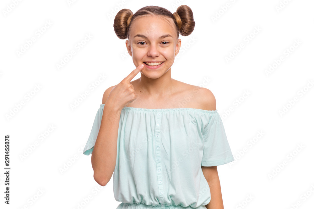 Portrait of smiling teen girl showing her teeth. Child pointing with ...