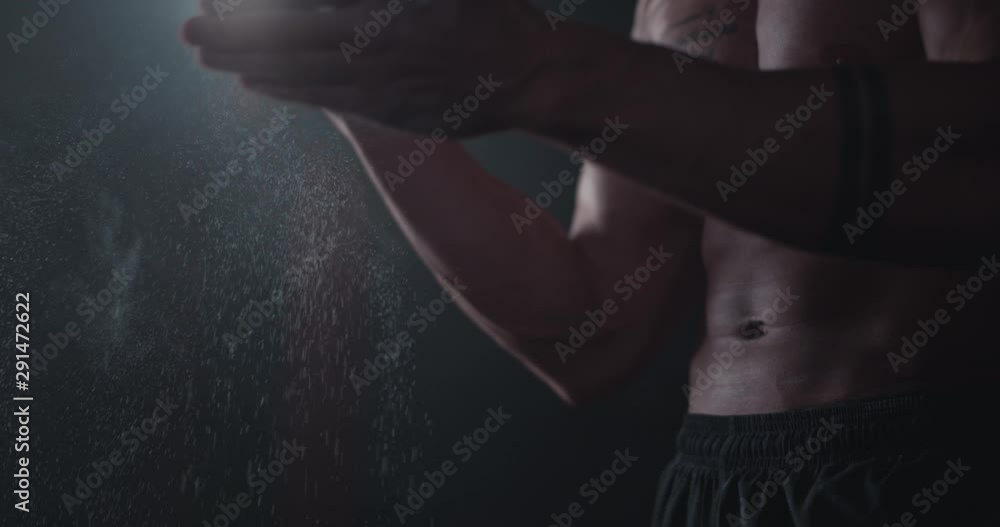 Details cross fitness concept guy clapping hands full of powder before ...