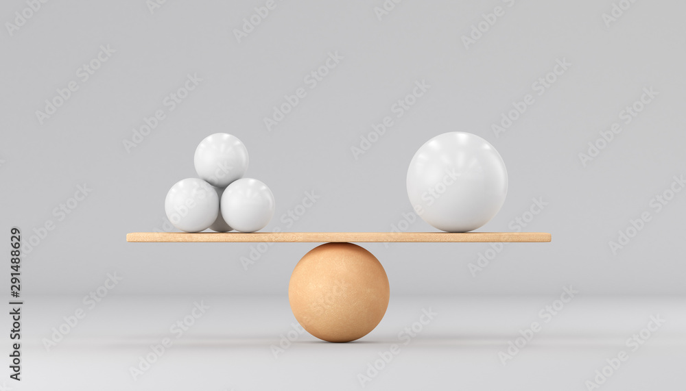 One big ball and many small ones. On wooden scales on a white ...
