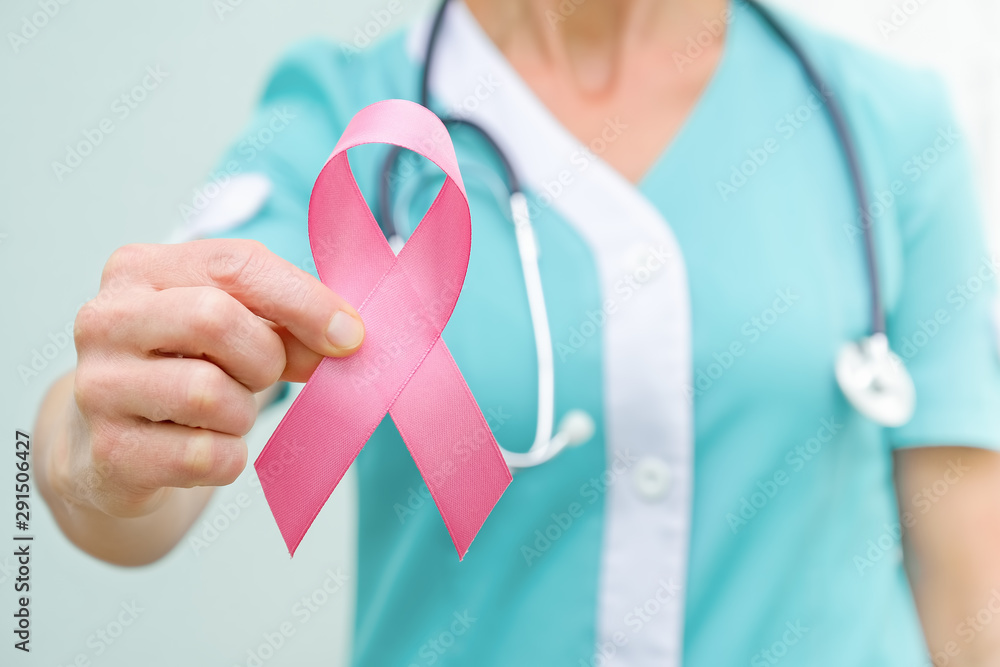 Pink ribbon for breast cancer awareness in doctor's hand, women breast ...
