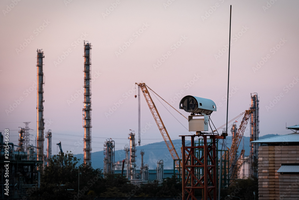 CCTV Camera for security in factory and storage tank at sunset time ...