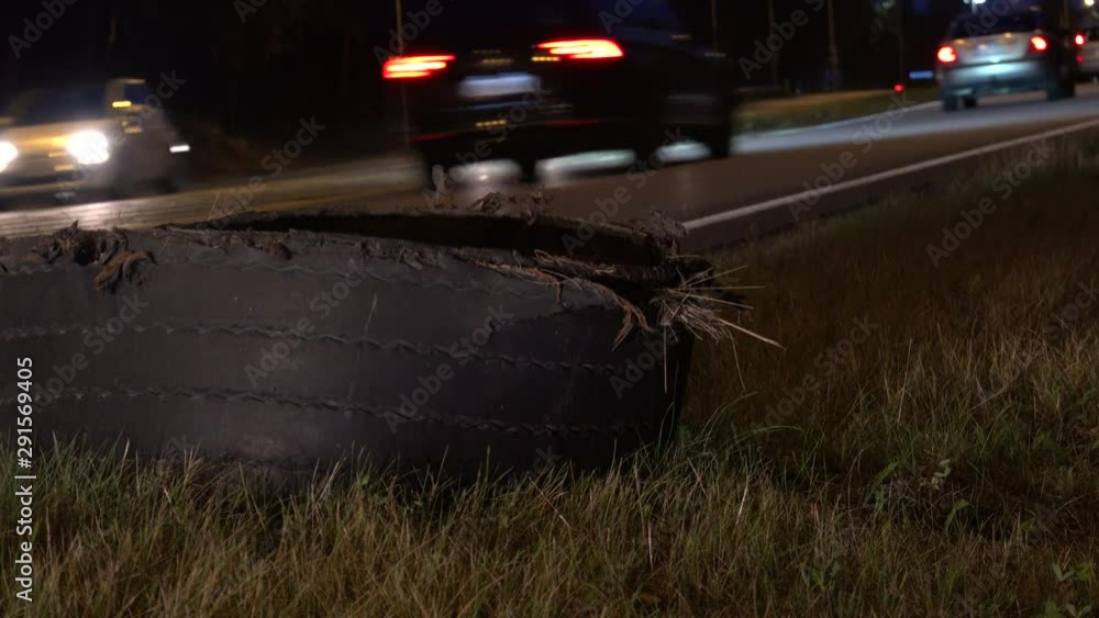 Blowout. Close up of exploded tire of semi truck on highway roadside at ...