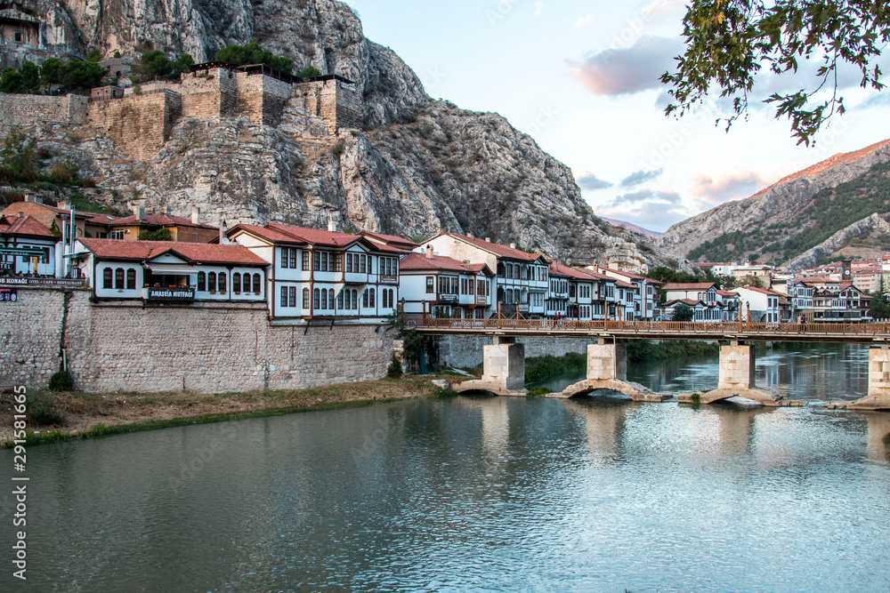 Old Ottoman houses and clock tower view by the Yesilirmak River in ...