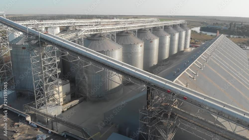 4K Aerial view of big grain elevators near the sea. Modern grain ...