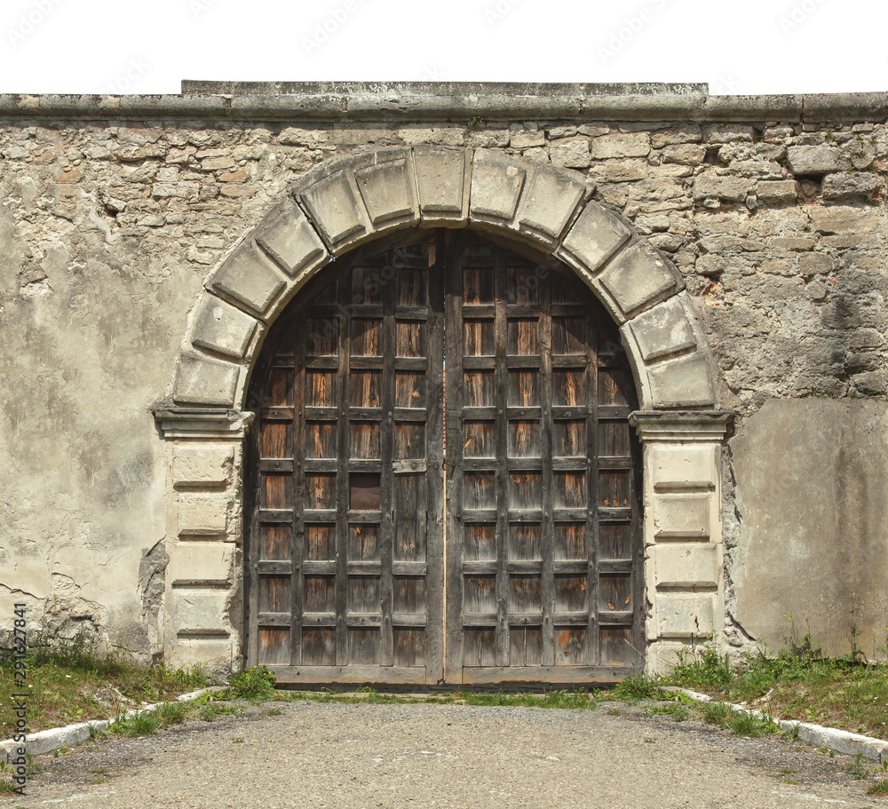 Medieval gate of an old castle surrounded by a stone wall ...