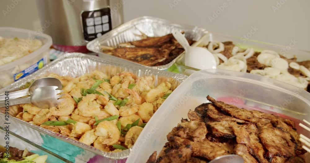 A variety of Asian Filipino food at a potluck party from seafood ...