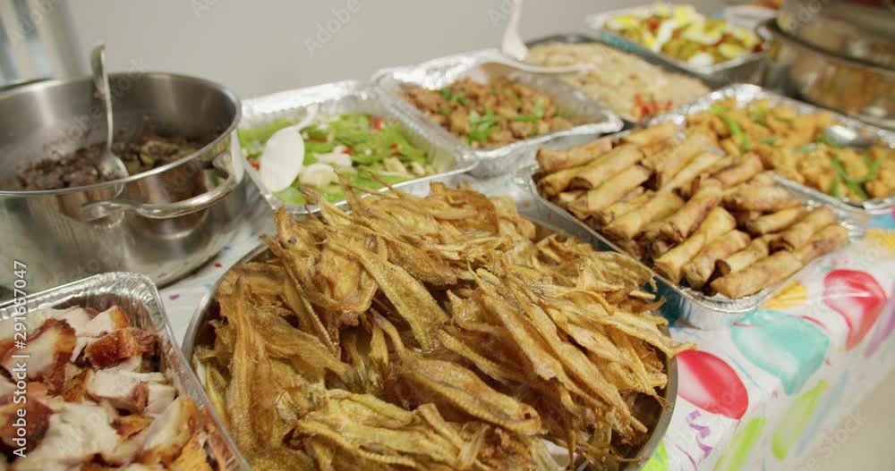 A variety of Asian Filipino food at a potluck party from pork and ...