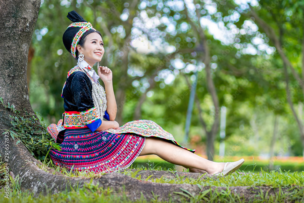 Hmong girl with traditional clothes costumes sitting sitting under tree ...