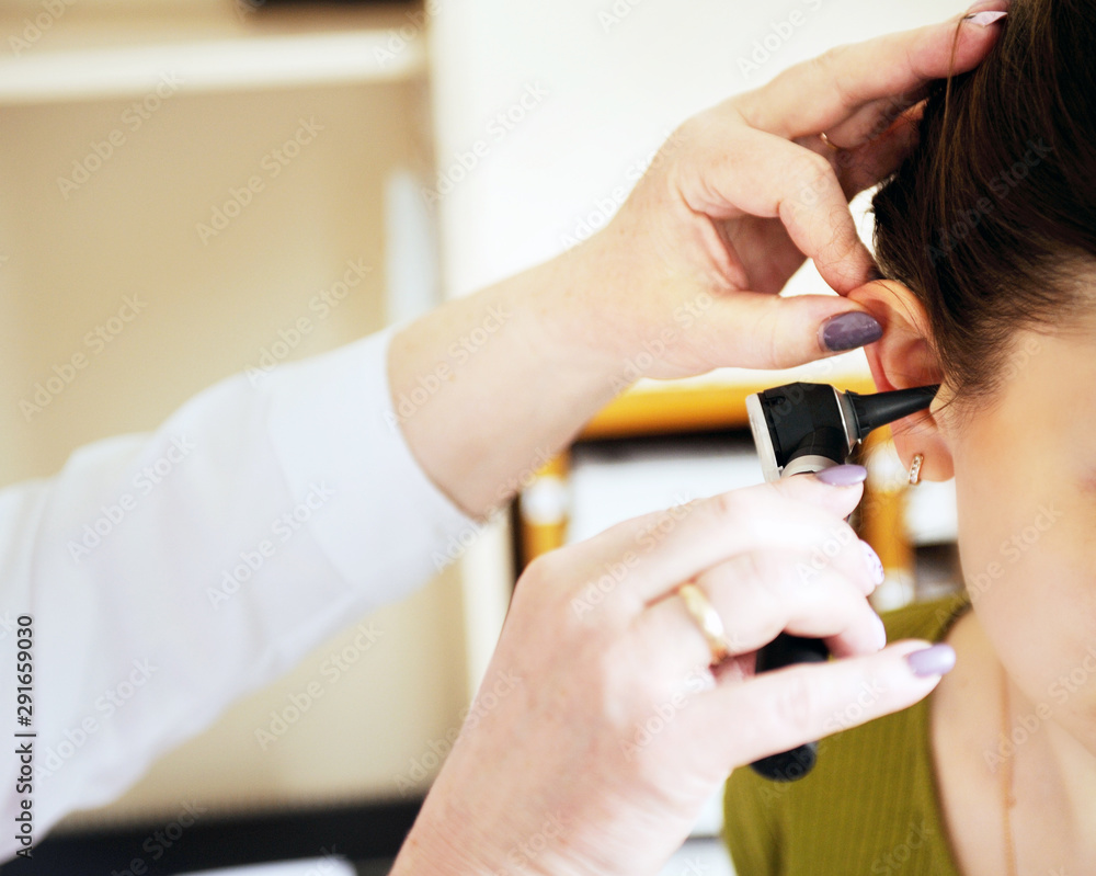 Doctor checking patients ear during medical examination Stock Photo ...