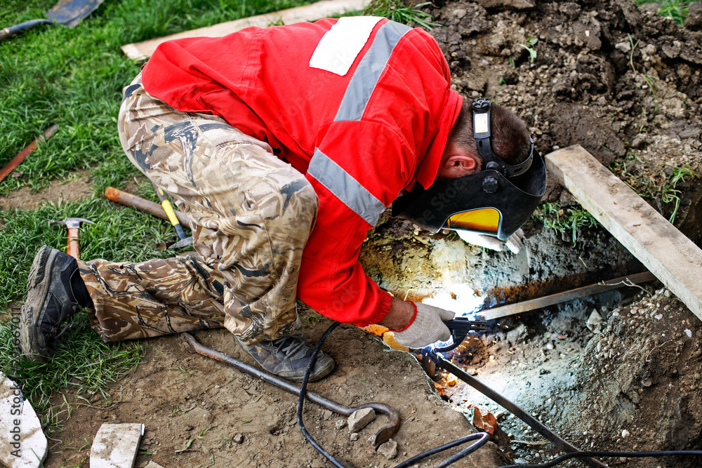 Man in welding mask performing weld construction. Welder constructing ...