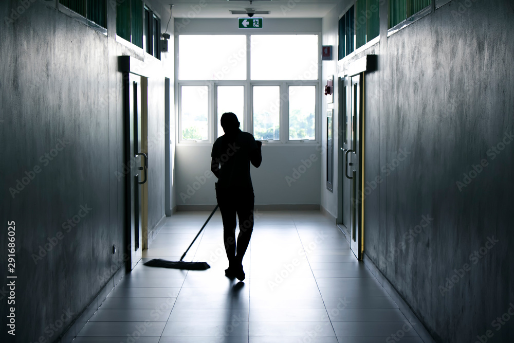 Janitor woman mopping floor in hallway office building or walkway after ...