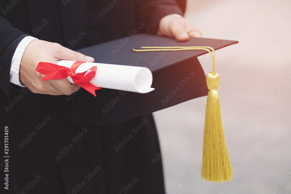 graduation, close up student holding hat tassel yellow gold with ...