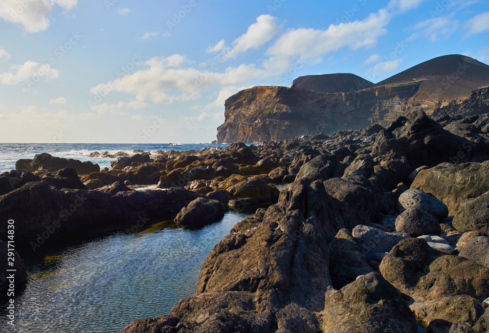 Coastal view of volcanic rocks and cliffs at Ponta Dos Capelinhos, the ...