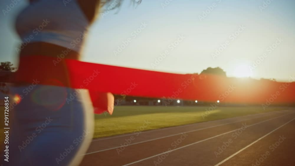 Beautiful Fit Female Runner Crossing the Finish Line on a Professional ...