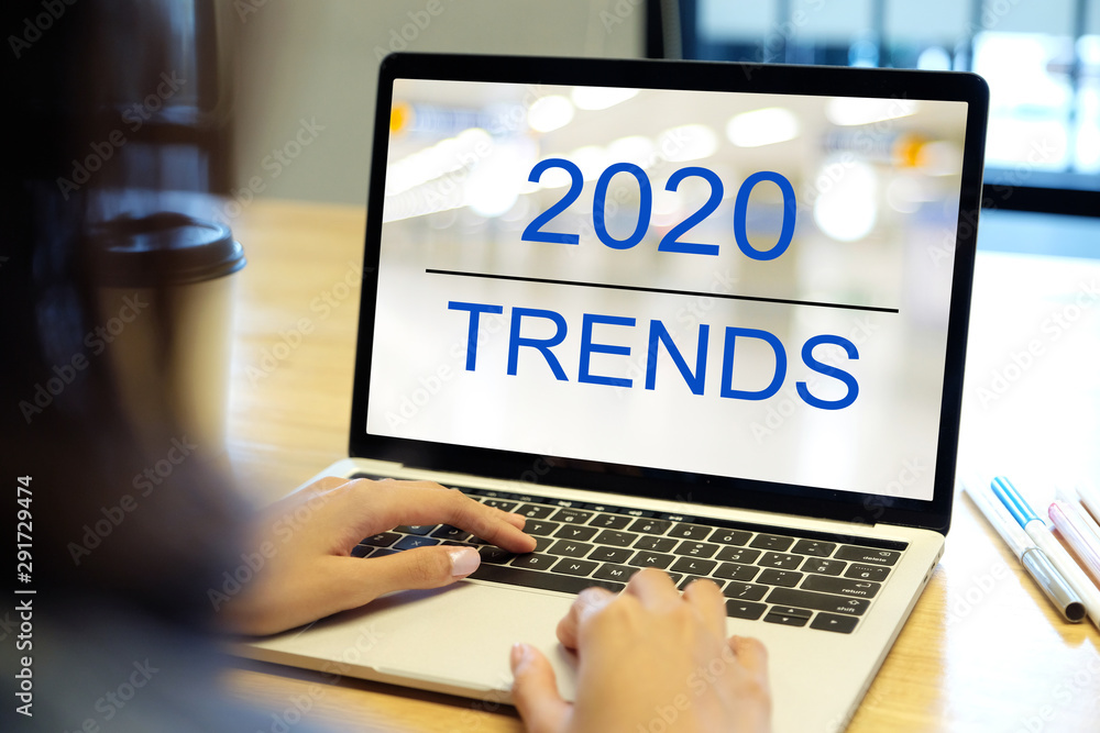2020 digital trends, Woman hand tying laptop computer with 2020 trends ...
