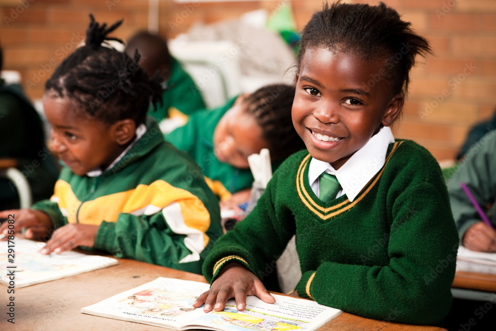 A young girl sitting at a desk in a classroom, Meyerton Primary School ...