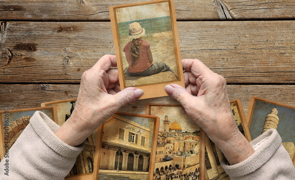 Old female hands hold old photo. Vintage photo cards background ...