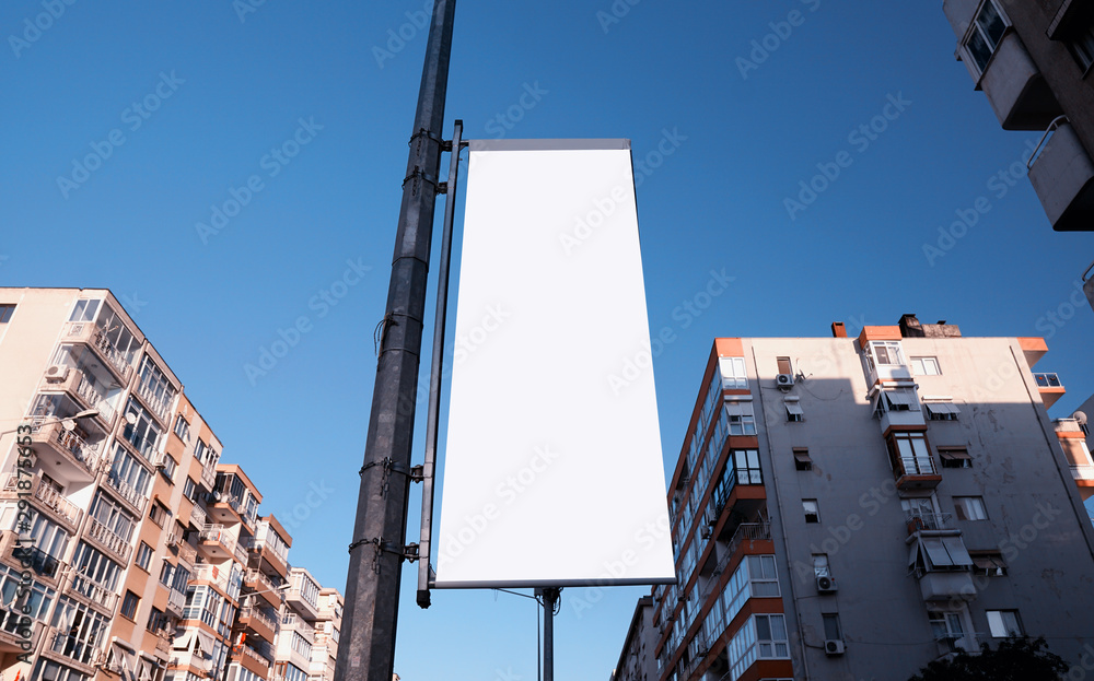 Blank, empty advertisement flag, banner on street with buildings ...