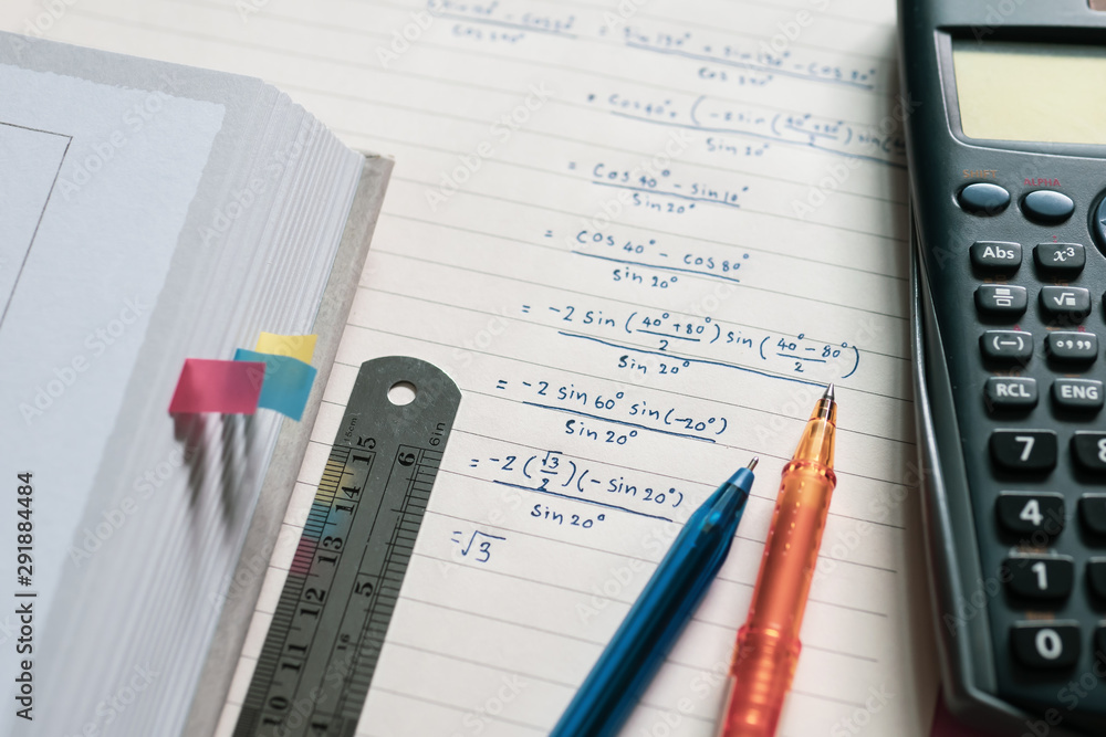 Solving math problem on paper Stock Photo | Adobe Stock