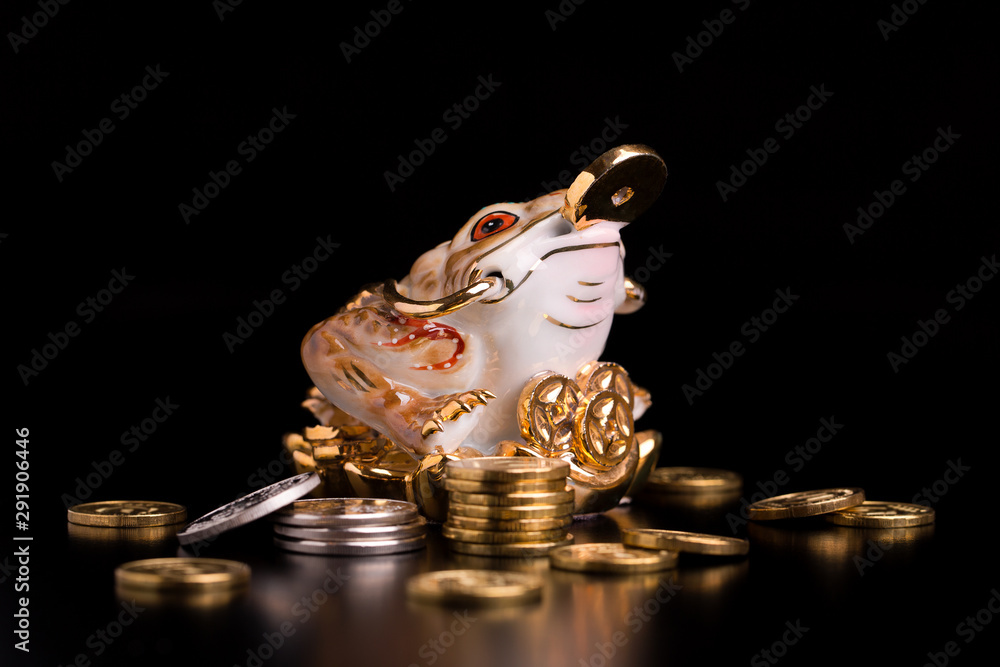 Figurine of a toad of money and wealth. Golden money toad and coins ...