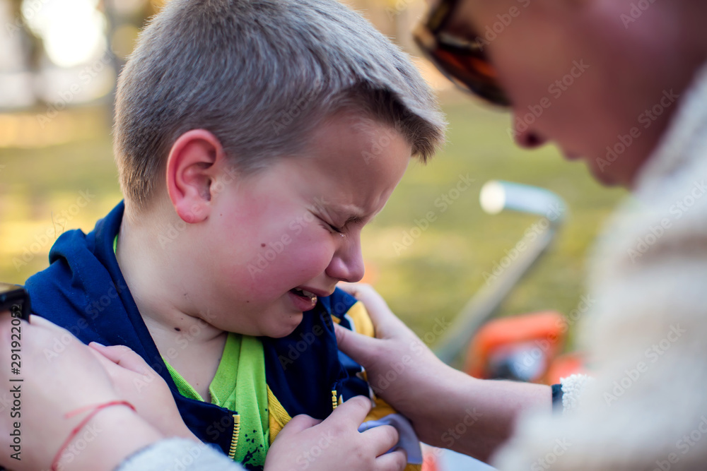 Boy crying and mother trying to calm him down. Children, parents and ...