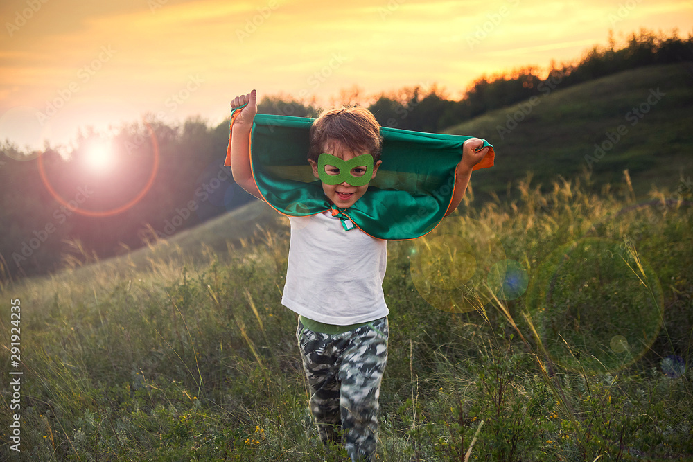 little boy playing a superhero. Kid in an Superhero's costume. happy ...