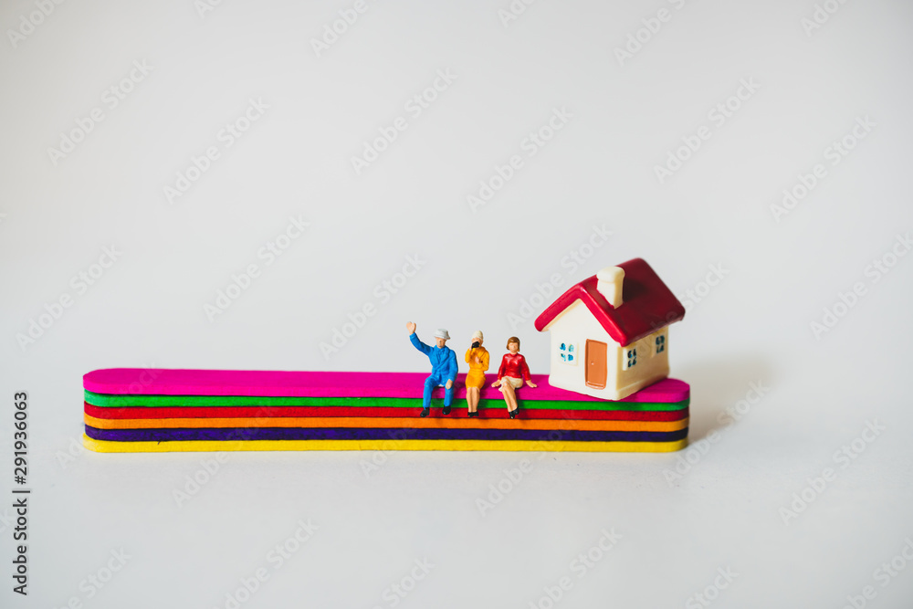 Miniature people, man and woman sitting on popsicle stick with mini ...