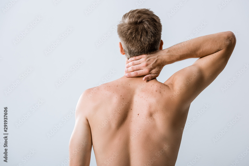 back view of shirtless man with neck pain isolated on grey Stock Photo ...