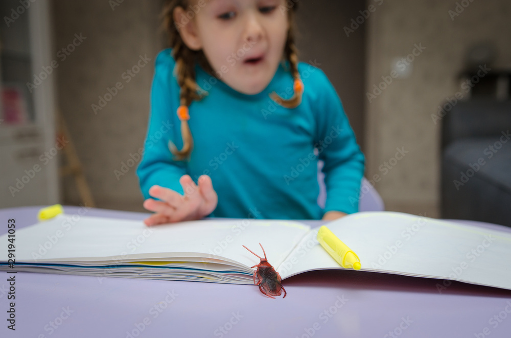 The cute little girl looking and afraid of cockroaches, Because the ...