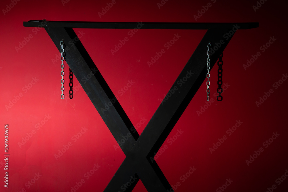 SM cross or Andreaskreuz is used in the BDSM scene on red background ...