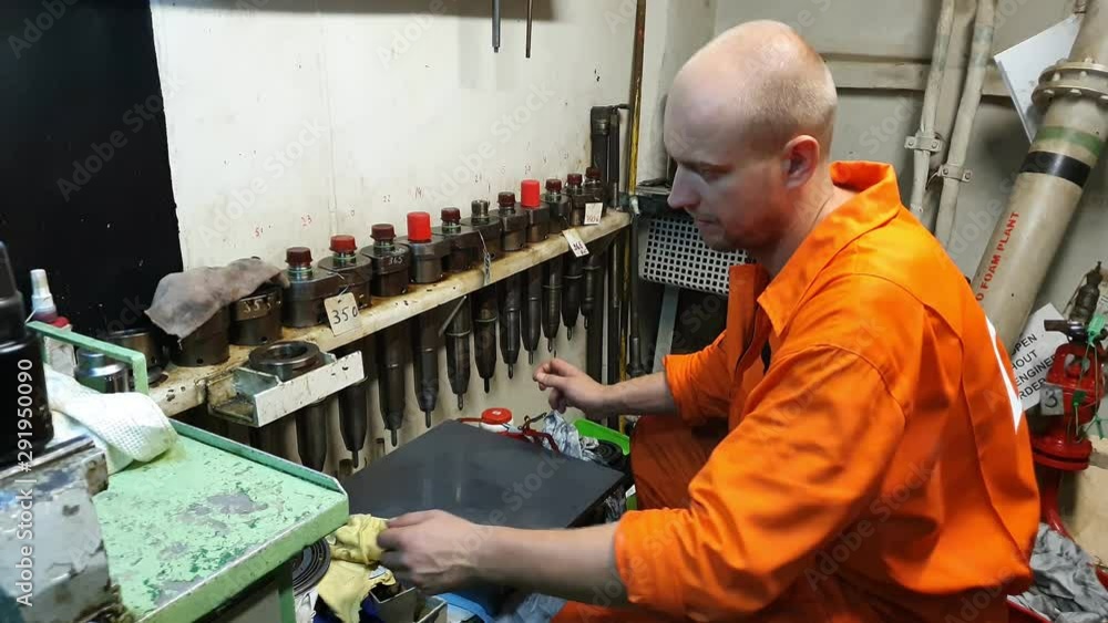 Vidéo Stock professional ship worker pours liquid grease on black ...
