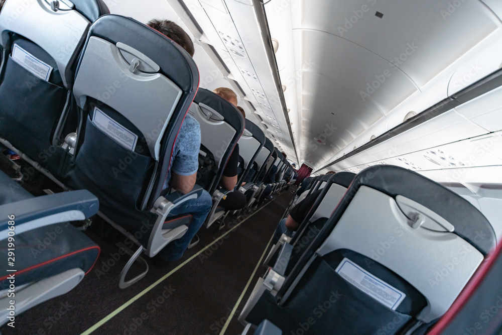 Airplane cabin seats with passengers. Economy class of new cheapest low ...