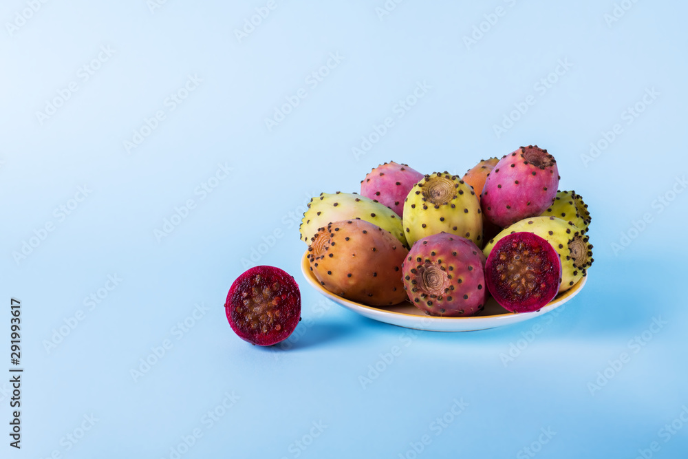 Whole fresh prickly pear fruit in a plate and cut in half an opuntia on ...