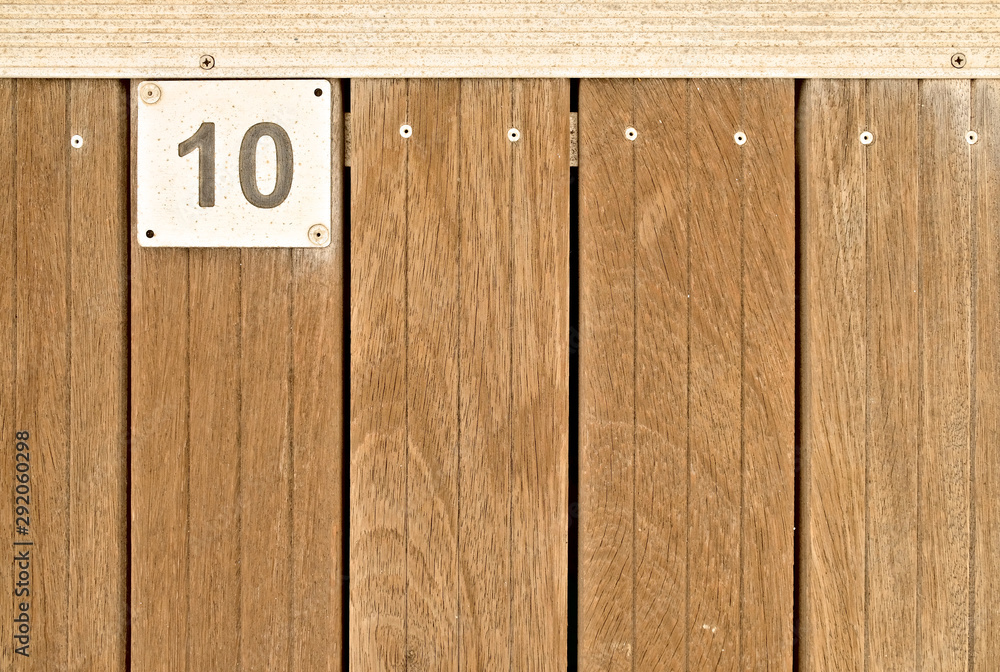 10, number ten, metal plate on wooden teak deck. Stock Photo | Adobe Stock