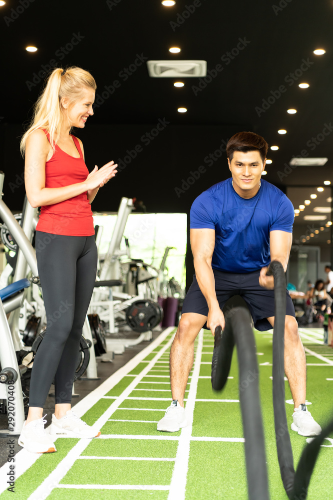 Young couples work out at the gym to strengthen the body. Each person ...