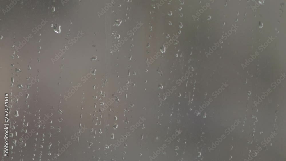 SLOW MOTION: Raindrops on a window, rain outside in background. Stock Video | Adobe Stock